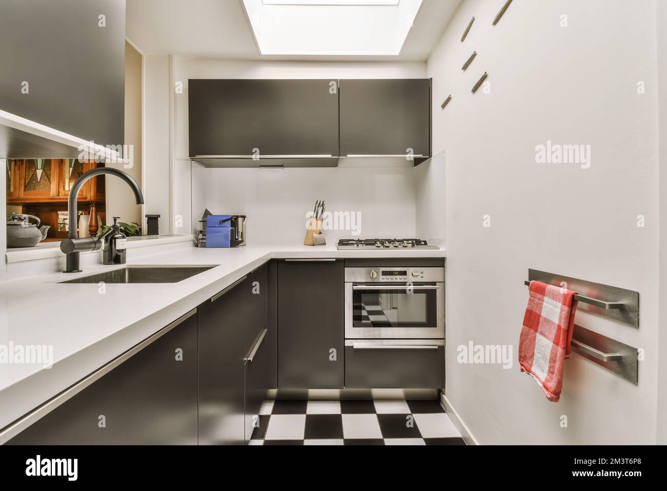 a modern kitchen with black and white checkered tiles on the floor ...