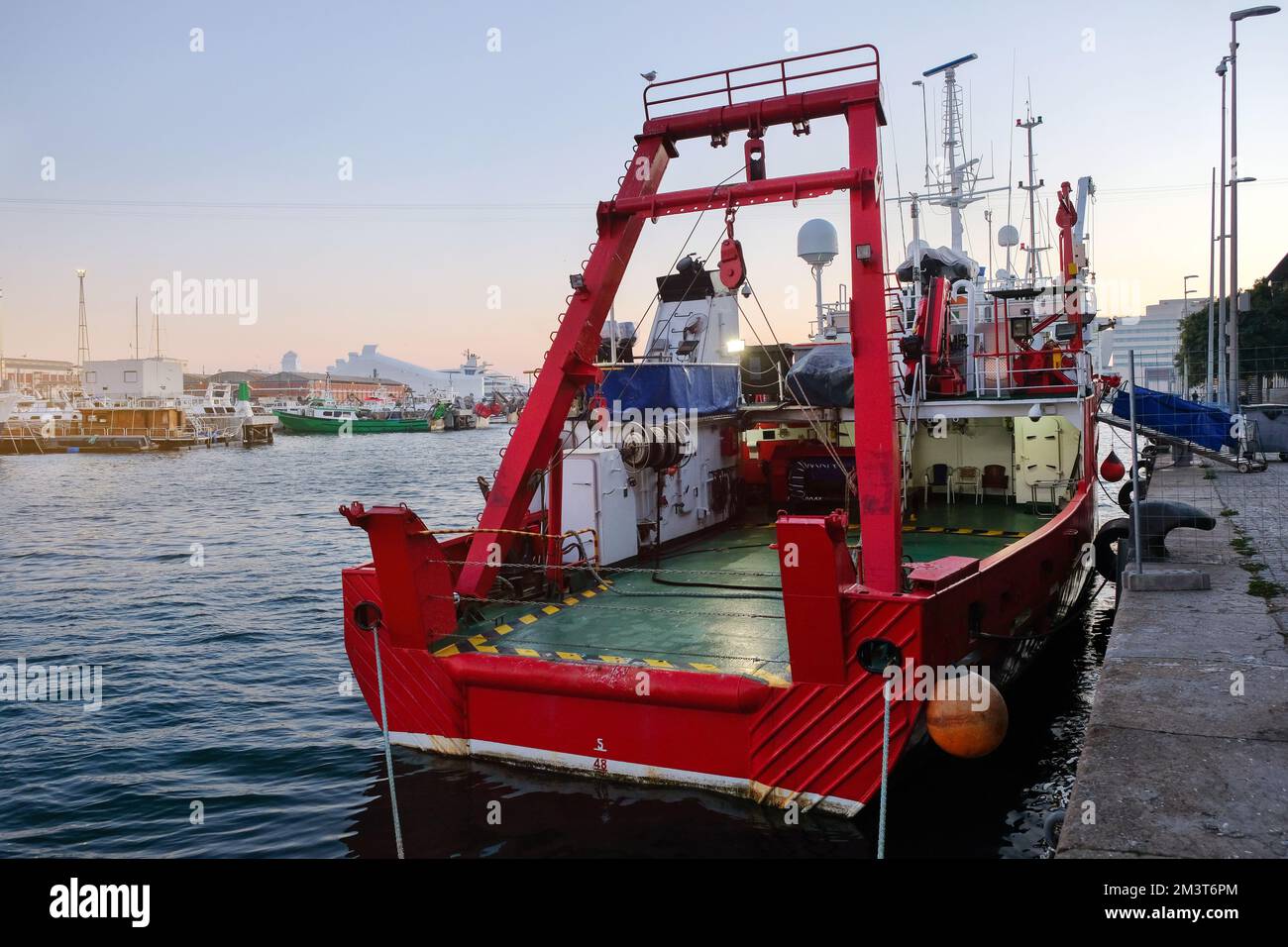 Cargo tug at the harbor pier. Sea port, boats and cranes Stock Photo ...