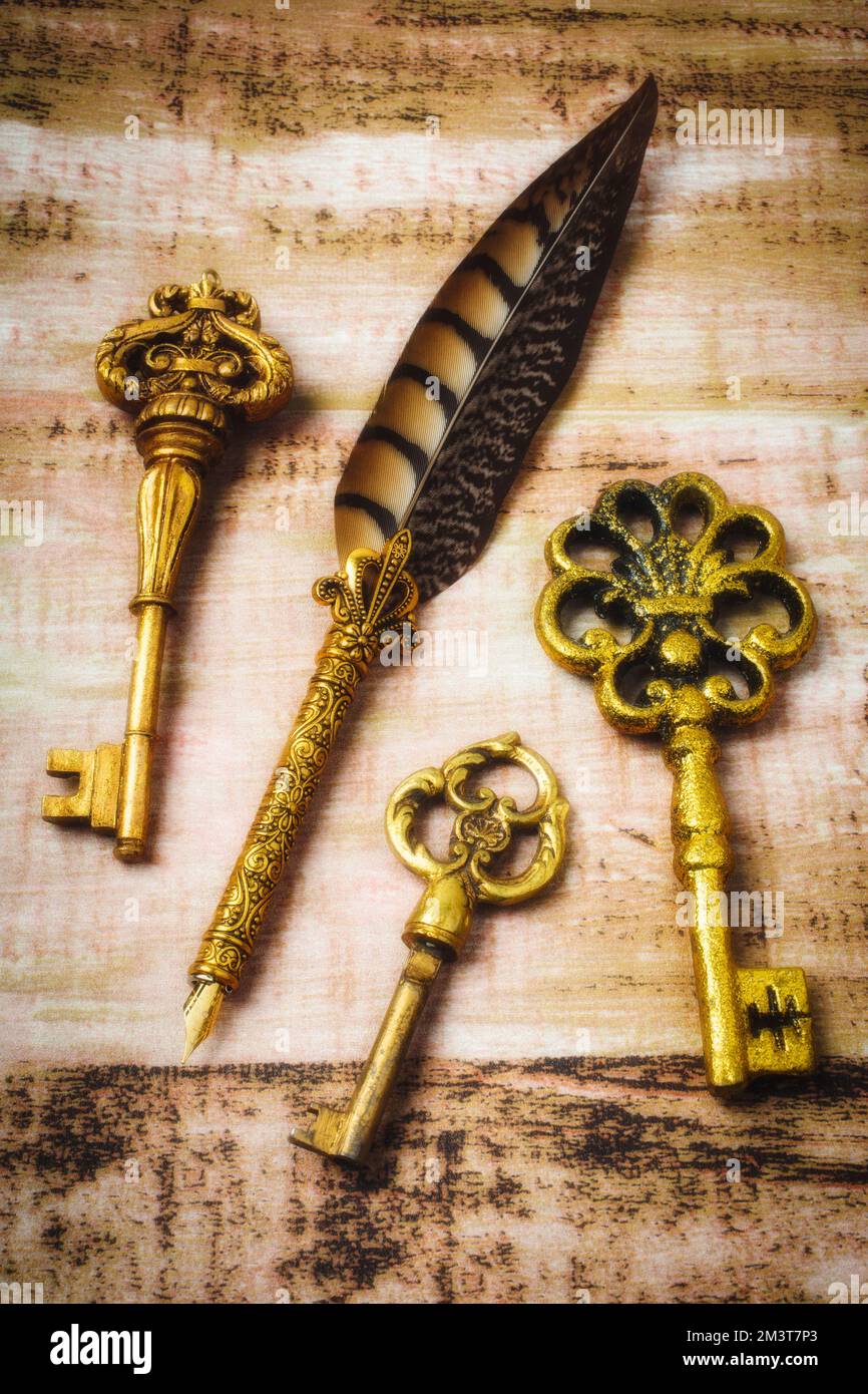 Gold Keys And Feather Pen Stock Photo - Alamy