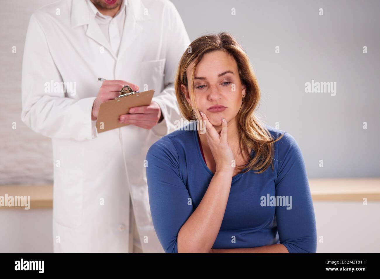 Female Patient With Headache In A Clinic Stock Photo - Alamy