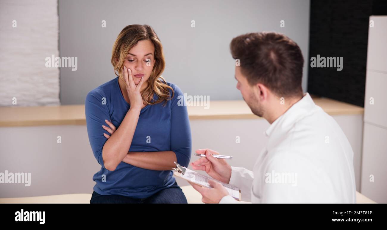 Female Patient With Headache In A Clinic Stock Photo - Alamy