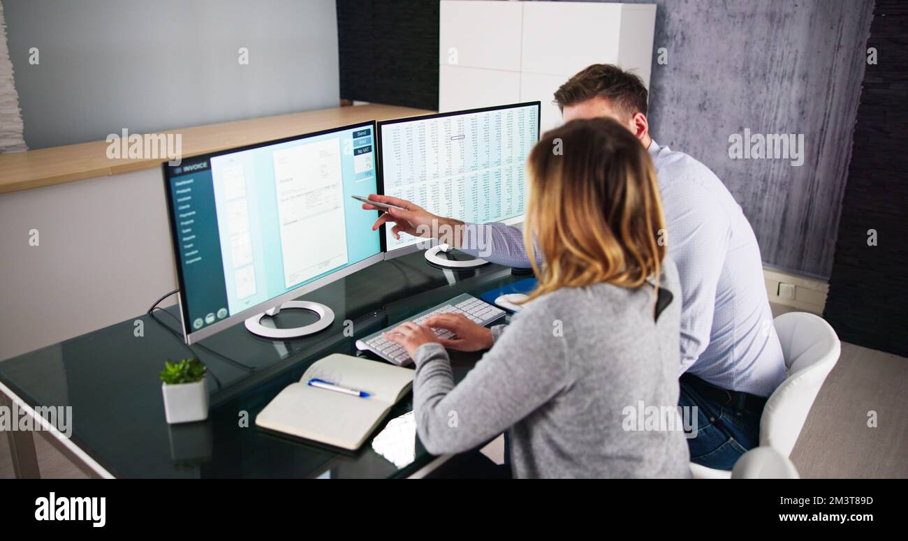 Spreadsheet And Electronic Invoice On Multiple Computer Screens Stock ...
