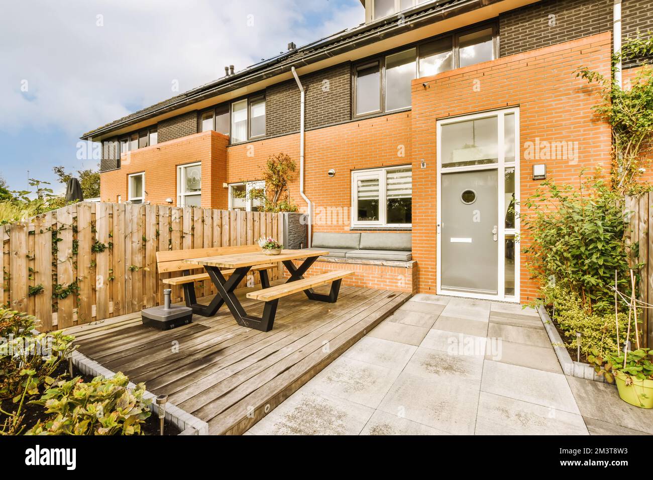 an outside area with a picnic table and bench in the middle of the yard ...