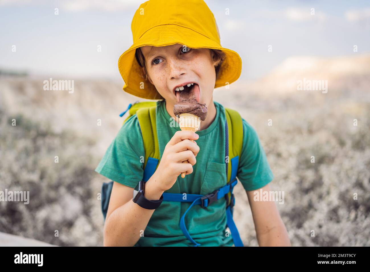 Boy tourist boy eating turkish ice cream while exploring valley with ...