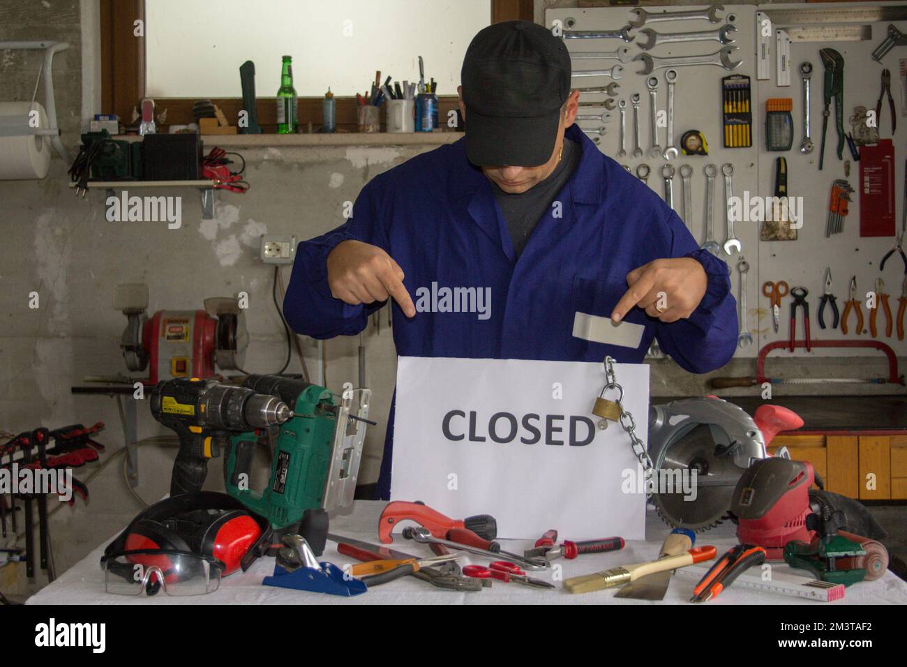 Craftsman in his workshop with a bench with tools in front of it and a ...