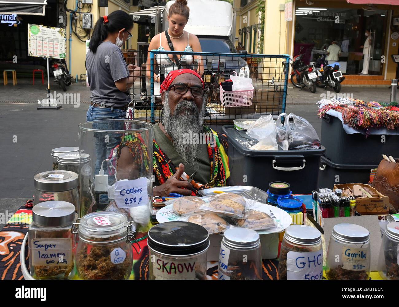 Bangkok, Thailand. 15th Dec, 2022. A Thai marijuana vendor sits at his ...