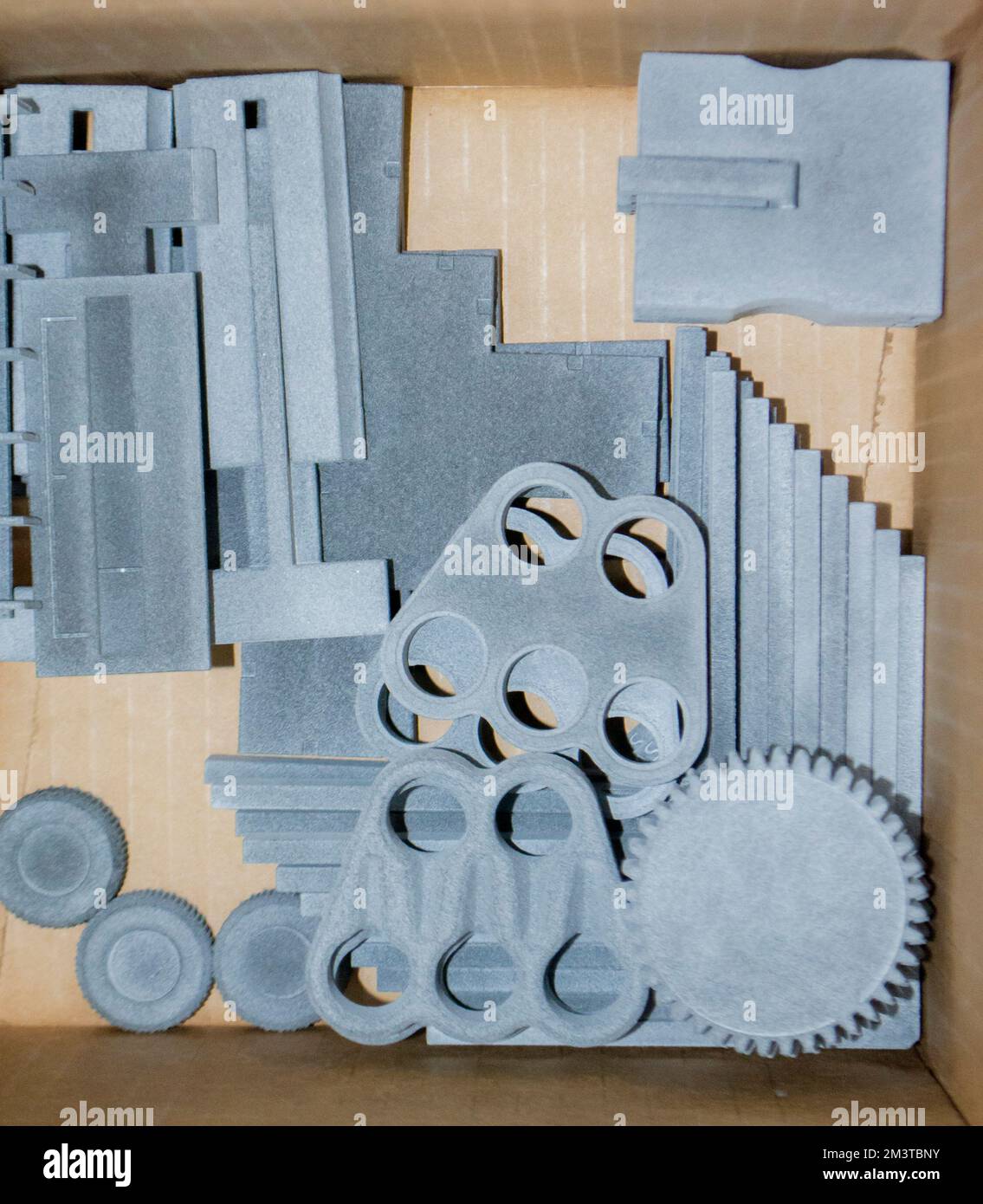 Gray models printed on 3D printer from polyamide powder in box close-up ...