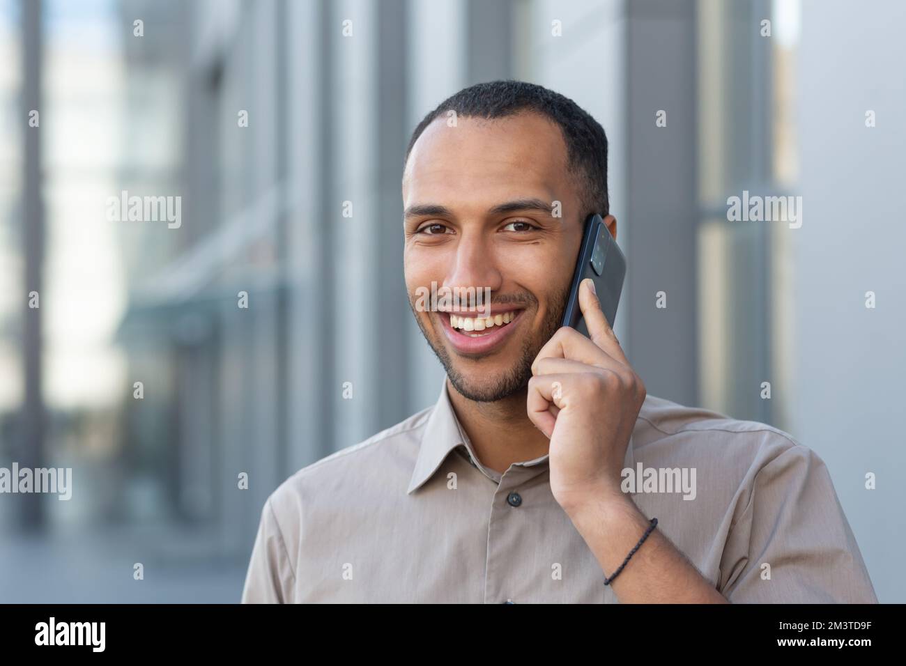 Hispanic man smiling happily on hi-res stock photography and images - Alamy