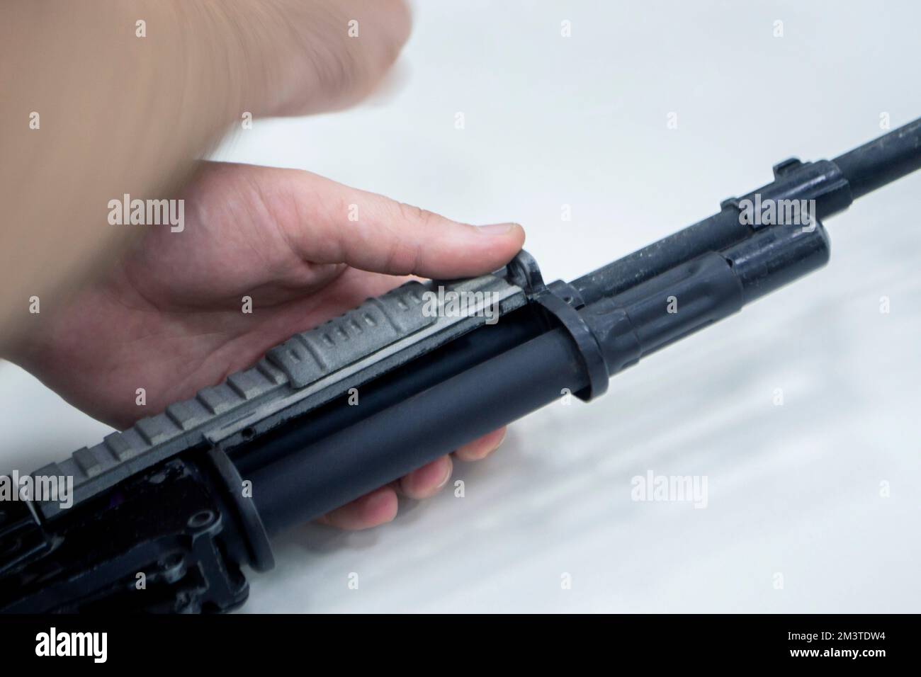 3D printed weapon parts. Man assembles weapon rifle, some parts printed ...