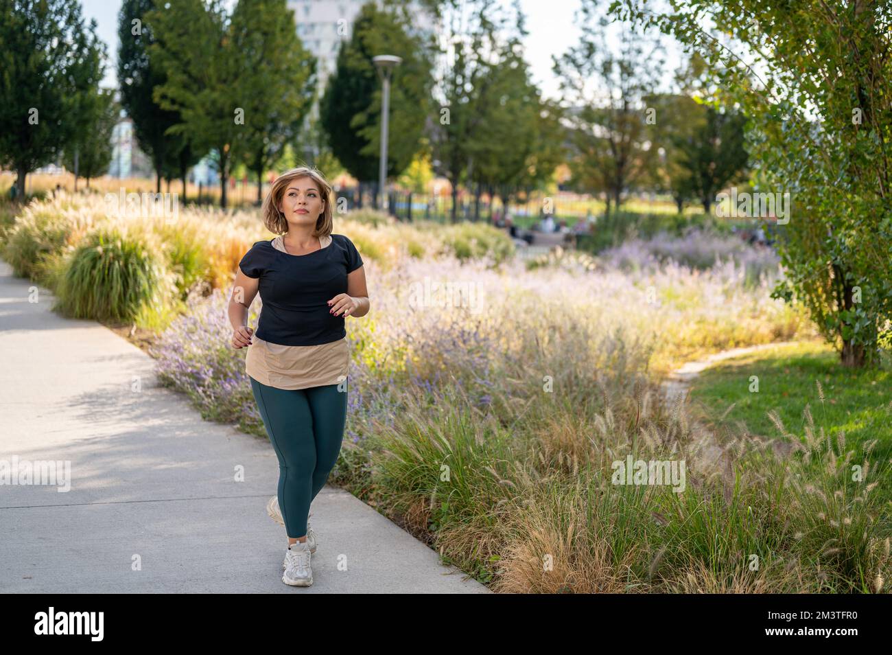 Sporty woman running outdoor, body positive and healthy lifestyle ...