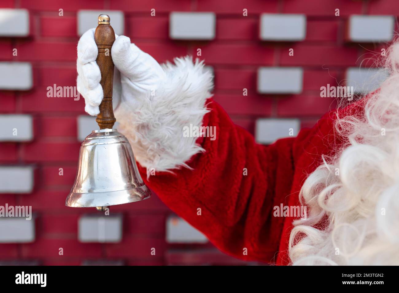 Close-up of a Santa hand holding a Christmas bell Stock Photo - Alamy