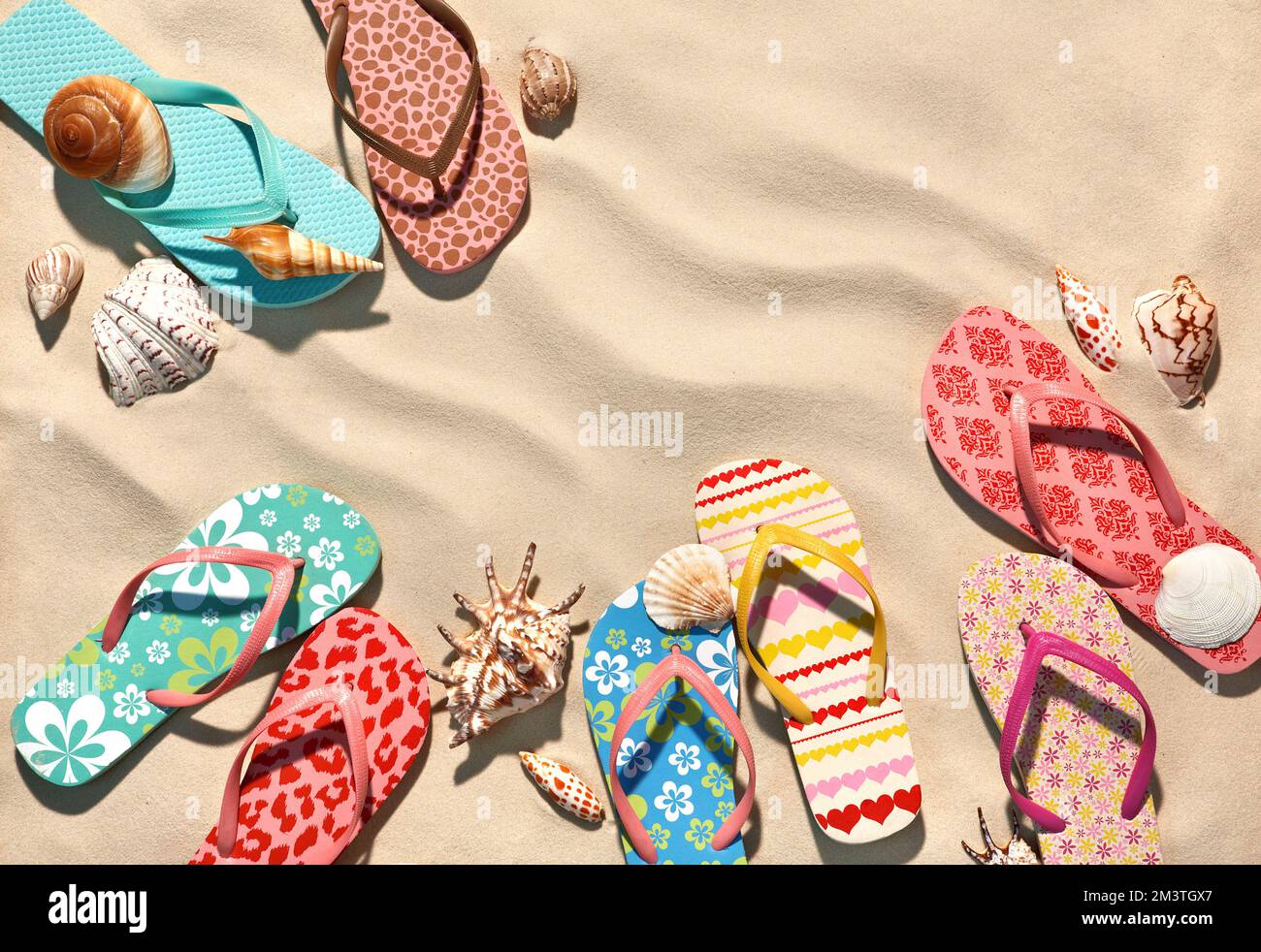 Summer background. Colorful flip flops on the sandy beach. Copy space ...