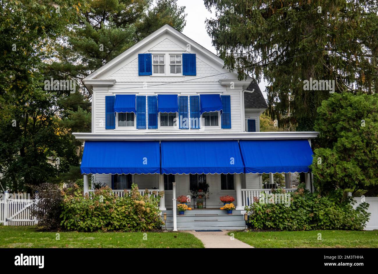 White house home bright blue awnings hi-res stock photography and ...
