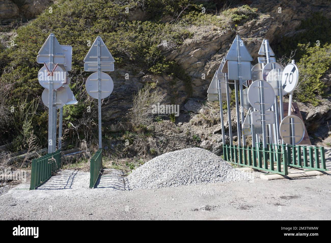 highway road signs stacked backward along the hill in the dirt for ...