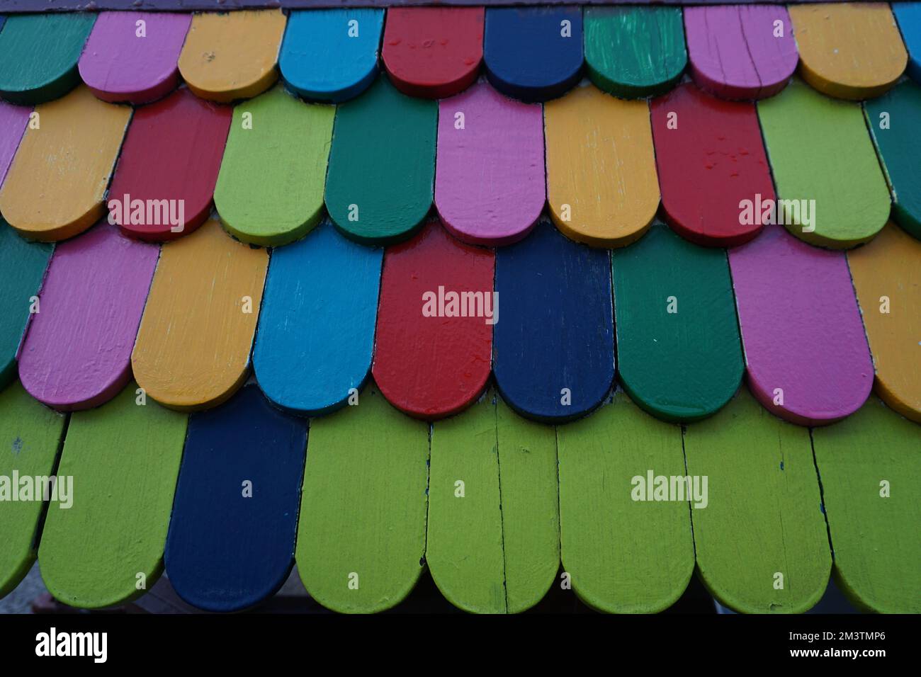 closeup of colorful painted wood tiles on a beach hut on the tropical ...