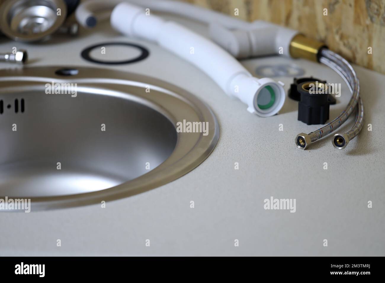 Plumbers tools and water tap ready for installation near sink on ...