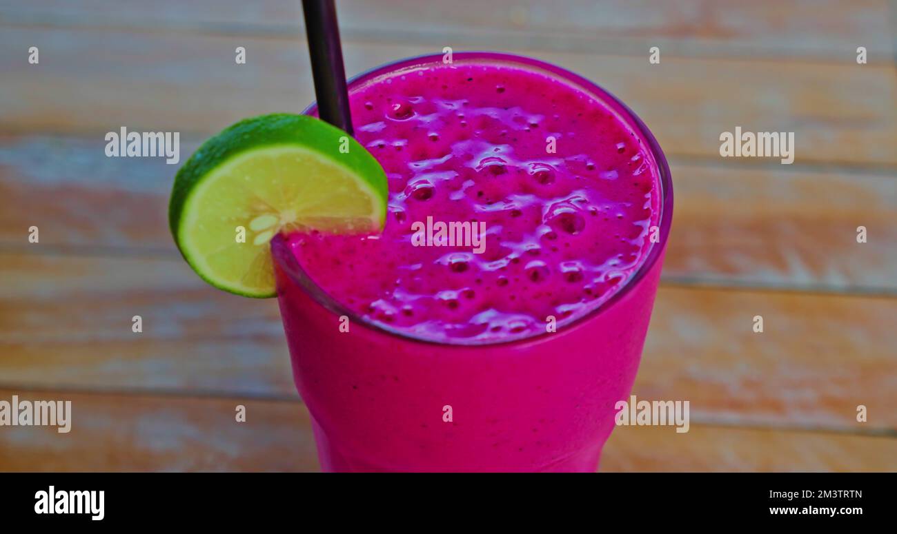 Pitaya dragon fruit smoothie fresh juice beverage drink on a wooden ...