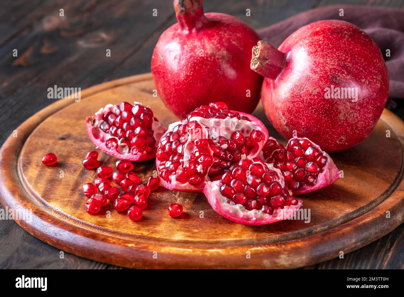 Fresh pomegranates on the wooden table: flat lay Stock Photo - Alamy