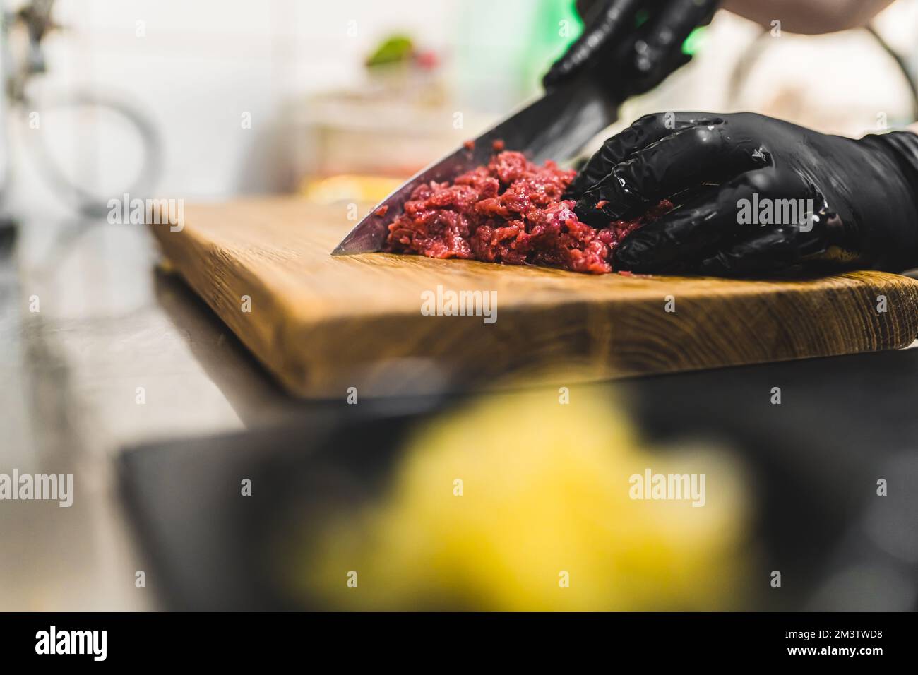 Chef in restaurant kitchen. Closeup portrait of beef tartare ...