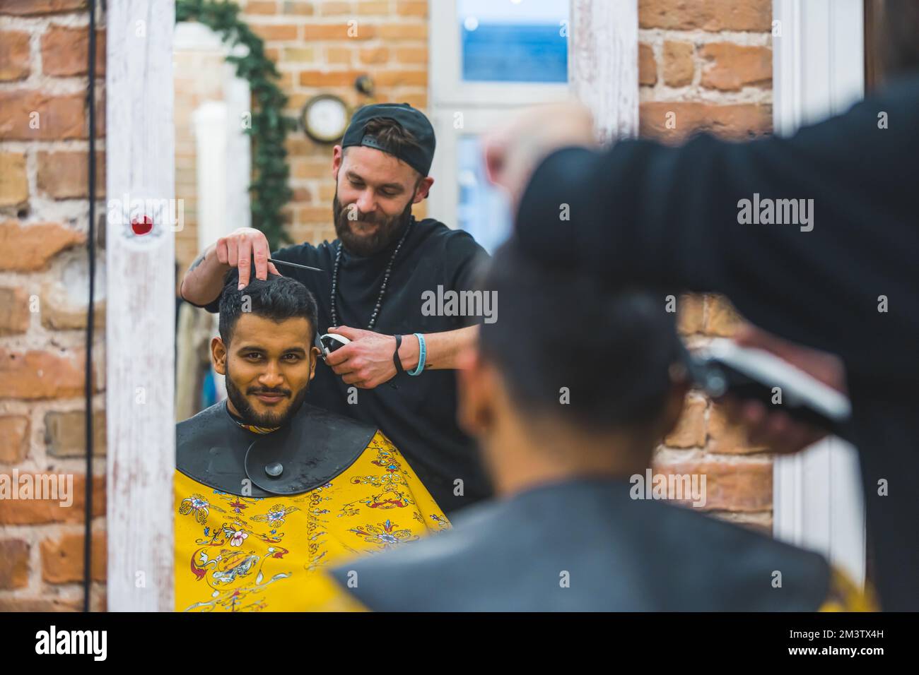 Rear view of a young man having a haircut in barbershop. High quality ...