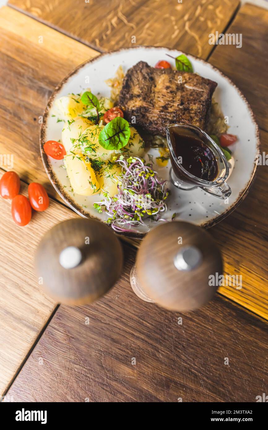 Vertical high-angle perspective of pork ribs served in a restaurant ...