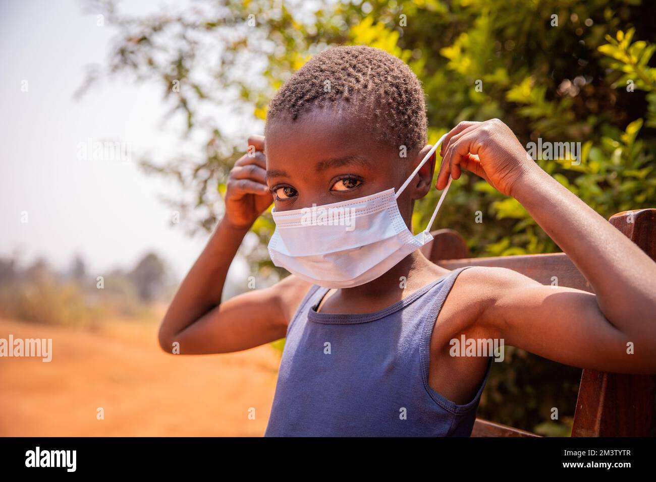 an African child wears a surgical mask to protect his health Stock ...