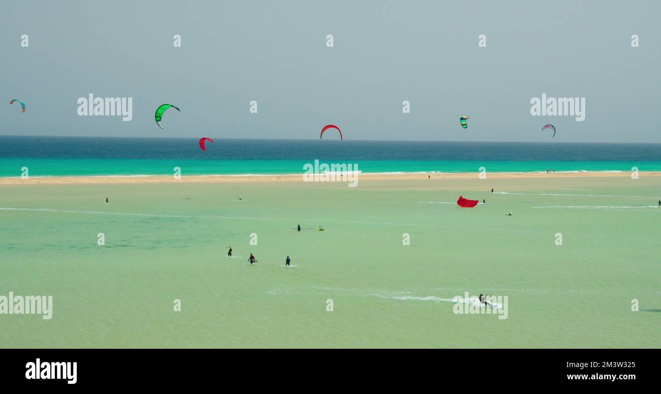Group of kite surfer kiteboarding on waves of Atlantic Ocean in Playa ...