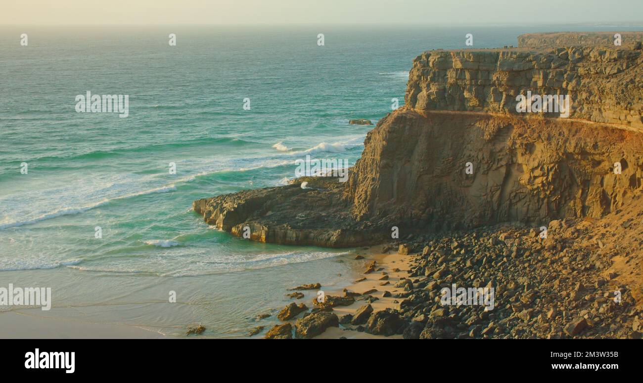 Fuerteventura cliff coast and sandstones. Ocean waves splashing on ...