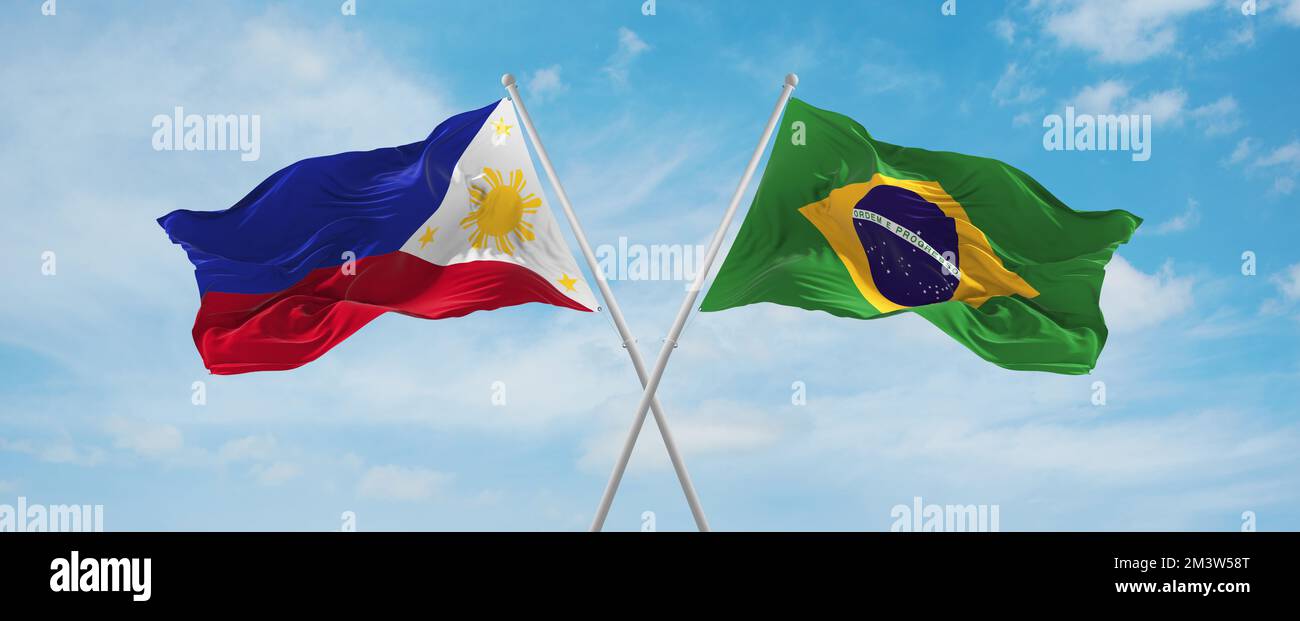 two crossed flags Brazil and Philippines waving in wind at cloudy sky ...