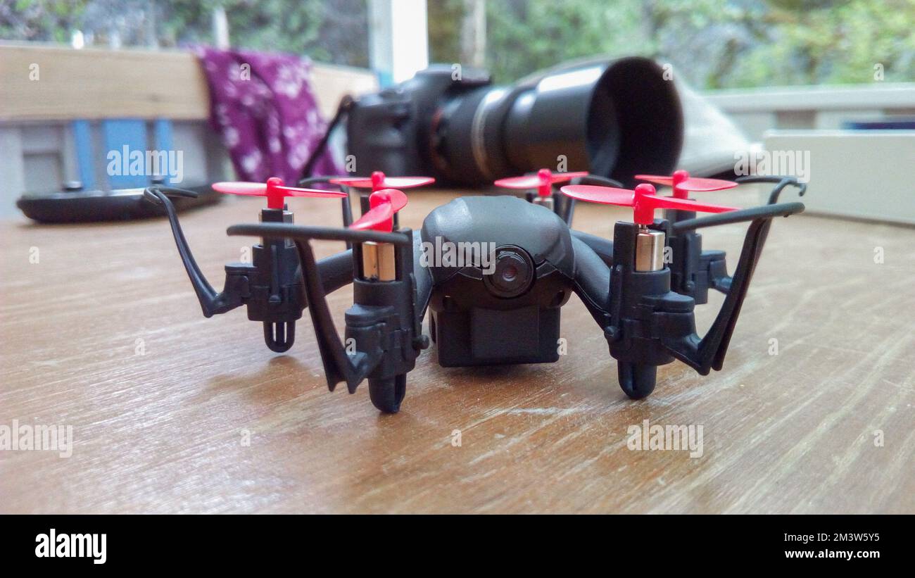 Close-up of a cheap drone and camera on a table Stock Photo - Alamy
