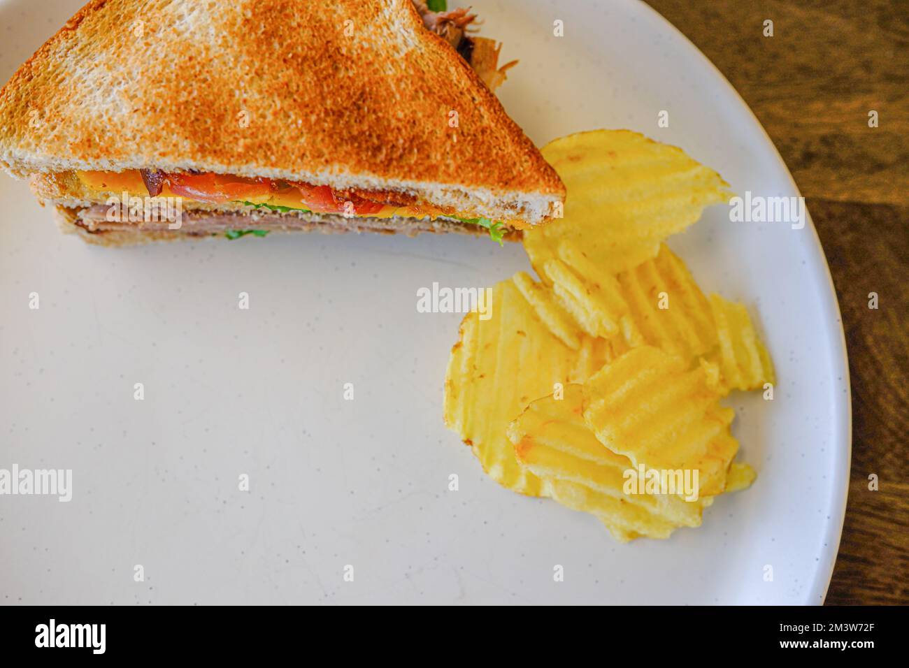 Toasted Texas Club Sandwitch ready to eat with crisps Stock Photo - Alamy
