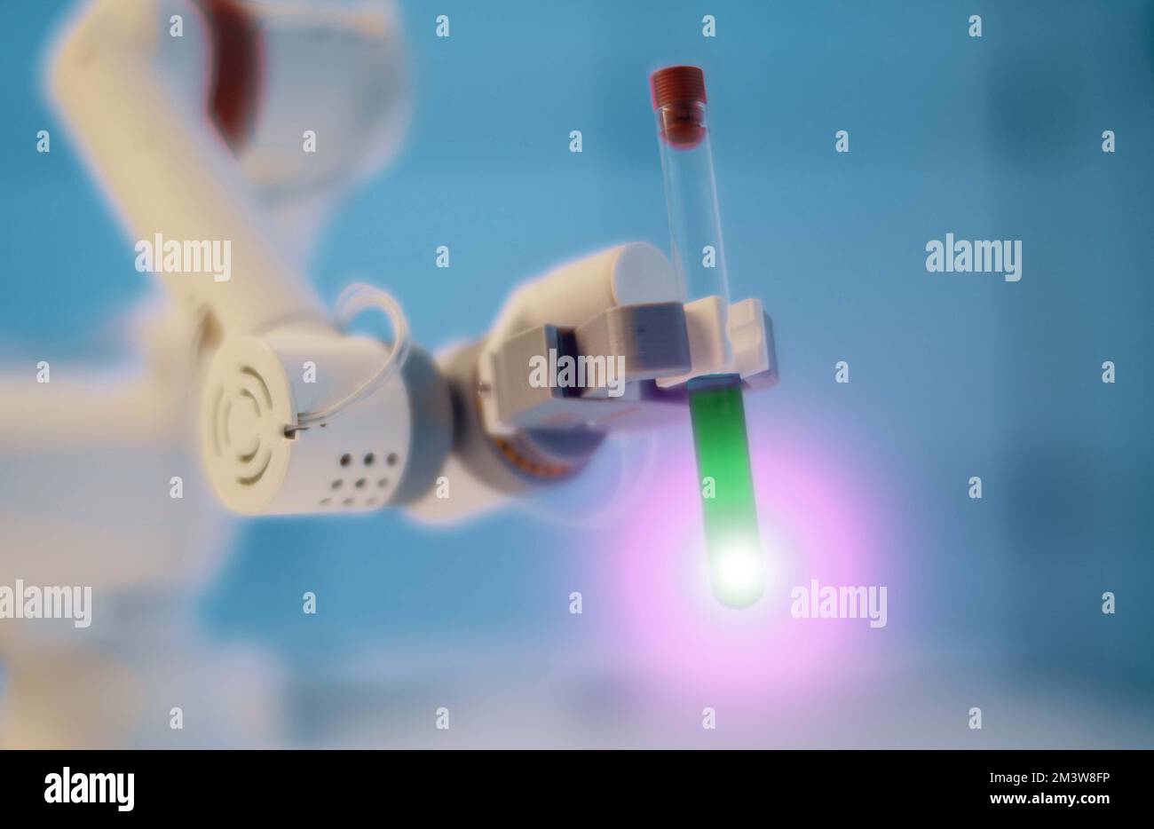 Robotic arm holding test tube Stock Photo - Alamy
