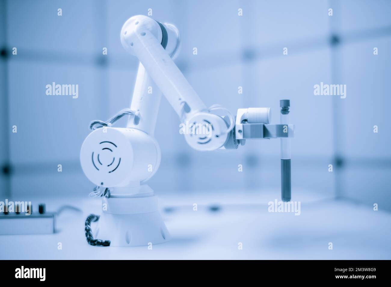 Robotic arm holding test tube Stock Photo - Alamy