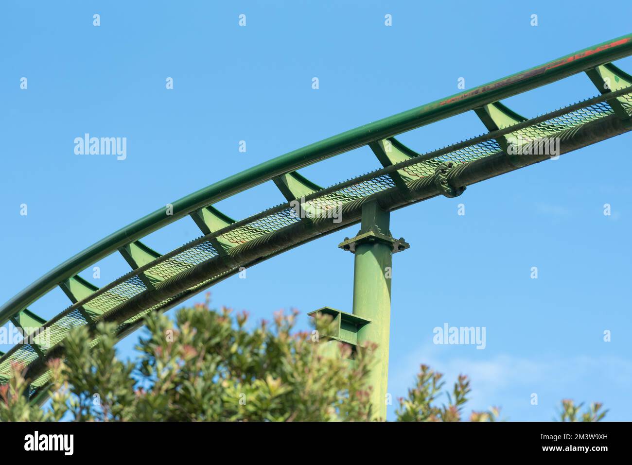 A roller coaster track painted in green view from below Stock Photo - Alamy