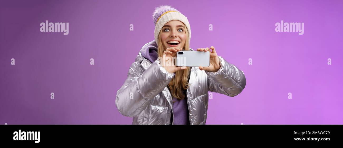 Amused fascinated female in silver jacket head smiling astonished ...