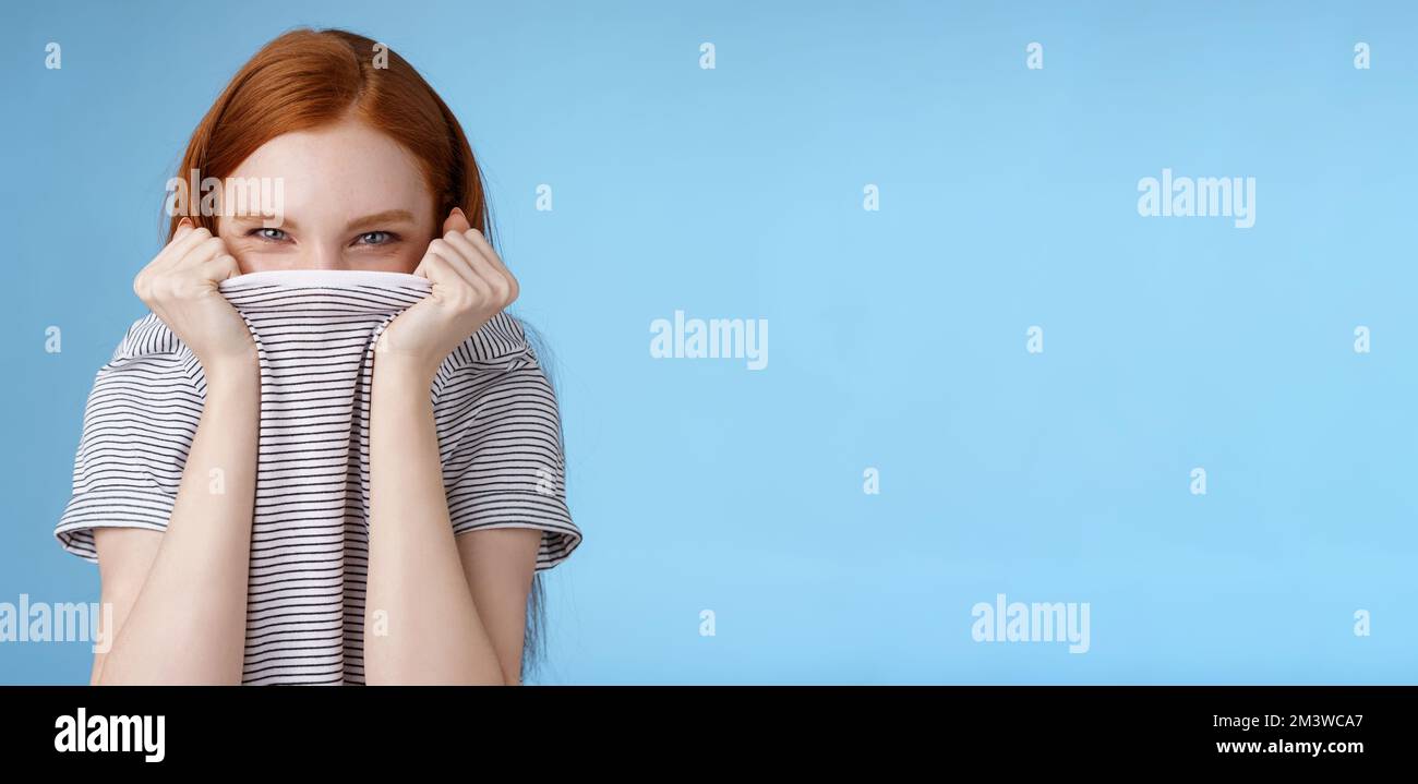 Silly flirty amused attractive playful redhead girlfriend hiding face ...