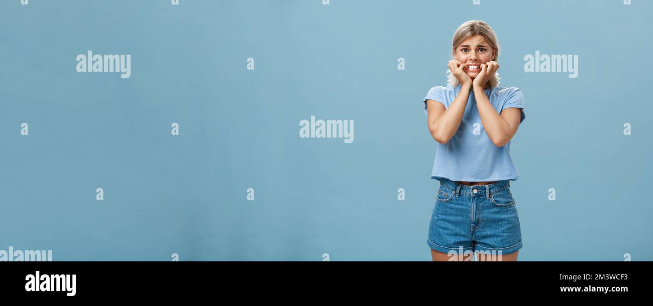 Attractive adult girl scared dad knows her secret standing over blue ...