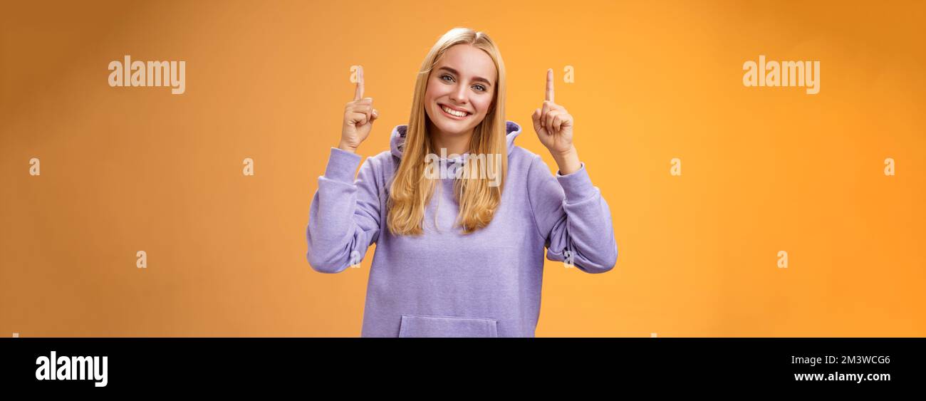 Helpful friendly-looking supportive charming female friend pointing up ...