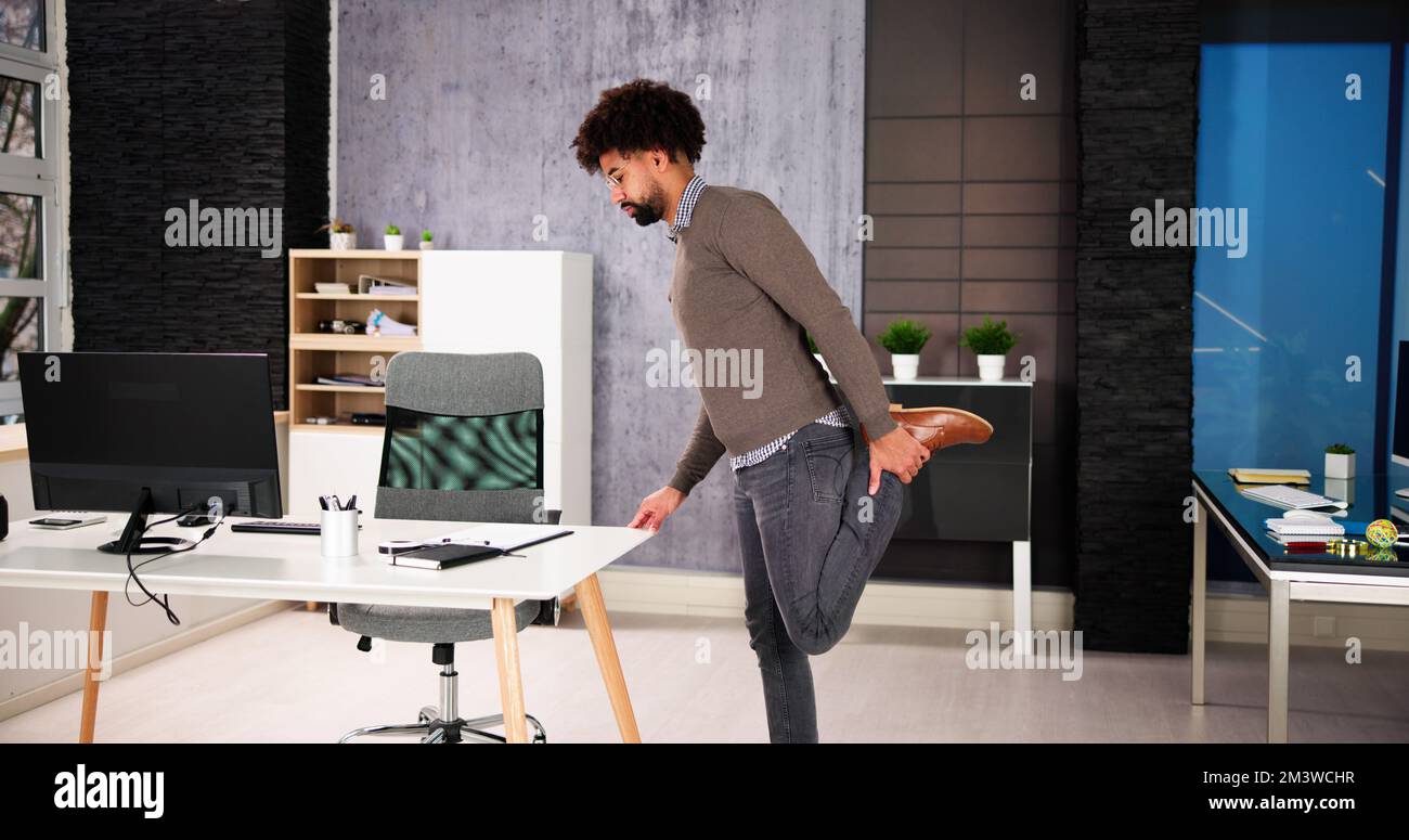 Yoga Workout In Office Behind Business Computer. Gymnastics And Leg ...