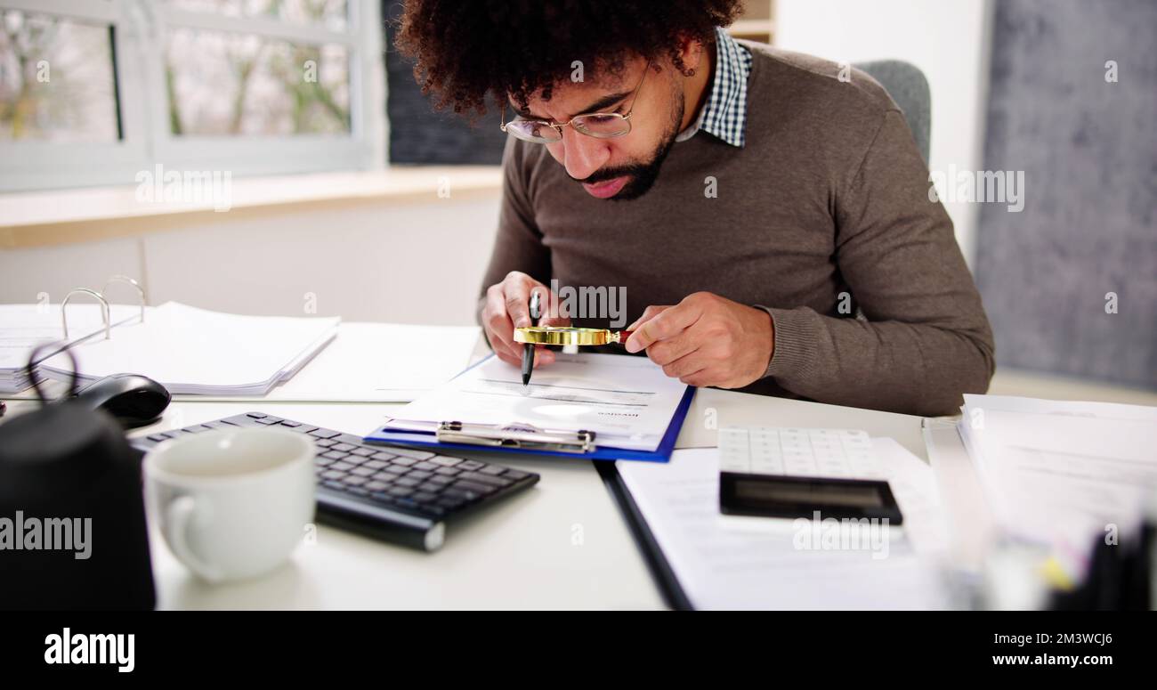 IRS Tax Audit. African Auditor Doing Debt Fraud Inspection Stock Photo ...