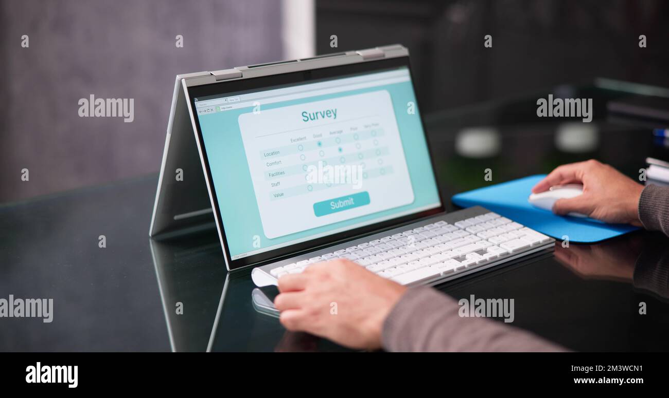 African Man Filling Survey Poll Or Form On Laptop Computer Stock Photo ...