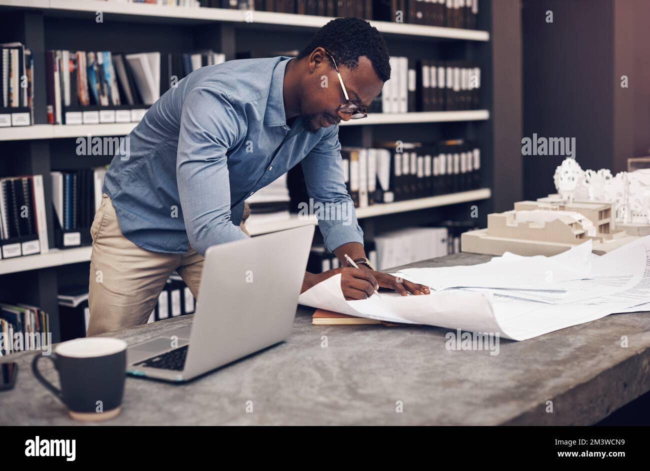 Paying attention to details. a handsome young male architect working ...