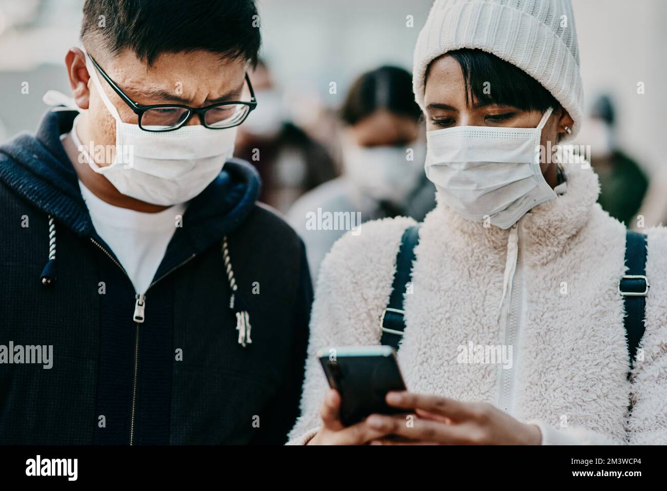 Stay connected, stay informed. a young man and woman using a smartphone ...