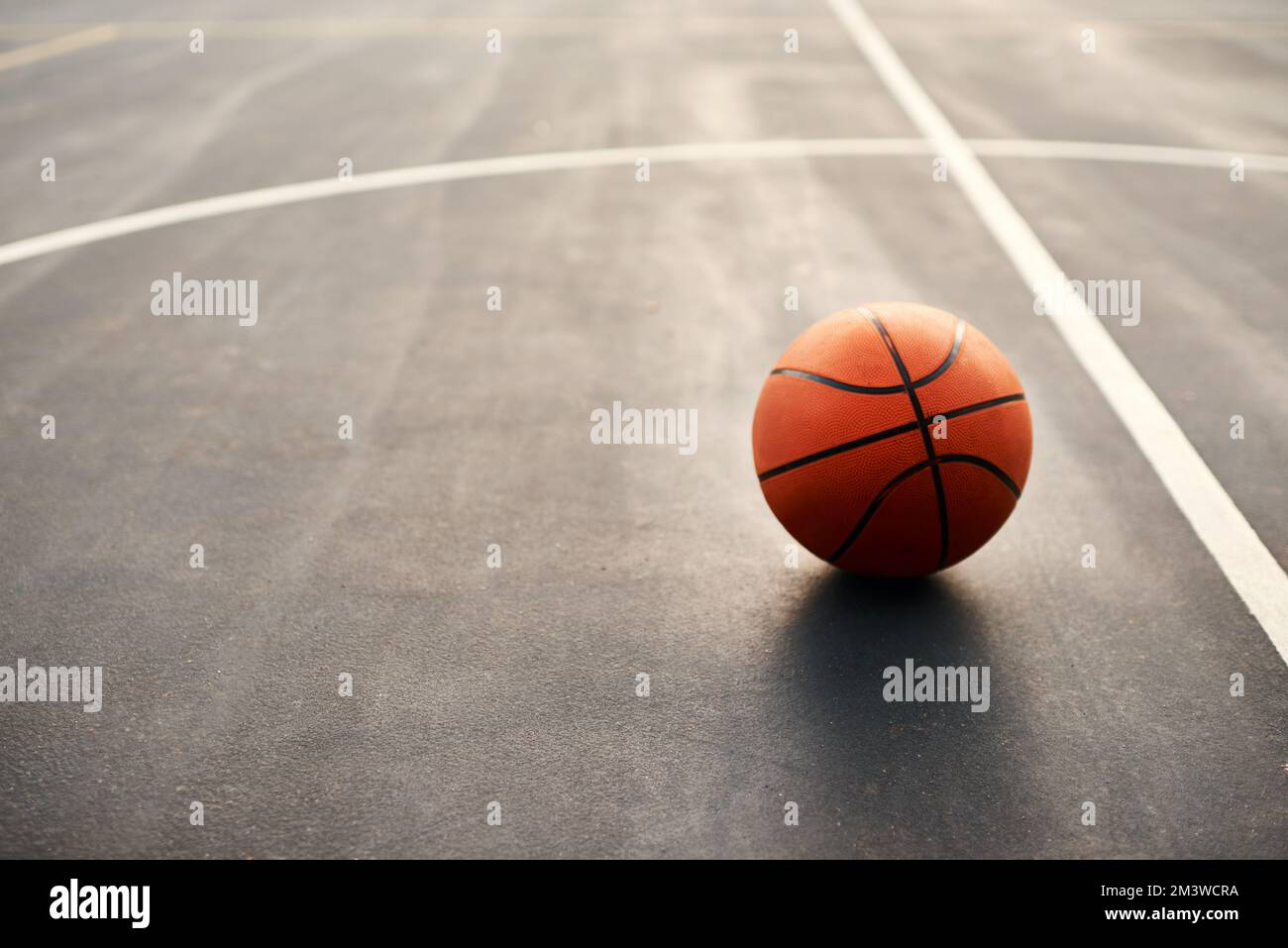 Lets play. a basketball on empty basketball court after a match during ...
