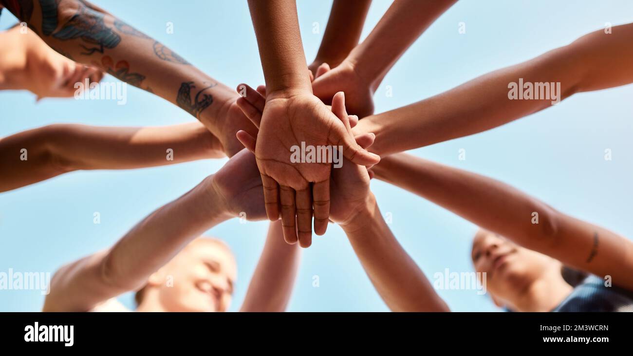 Weve got eachothers backs. Low angle shot of an unrecognizable group of ...