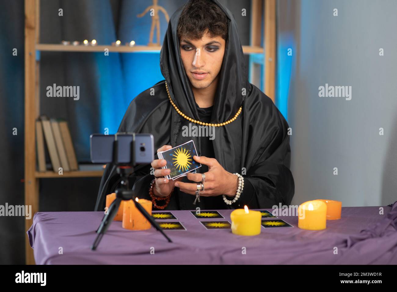 Man fortune teller reading tarot cards online using smartphone. New ...