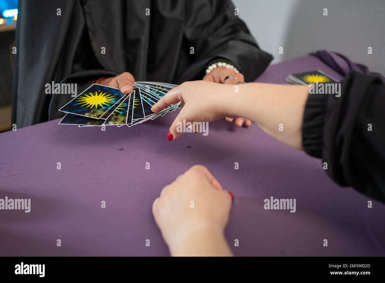 Fortune teller man reading tarot cards having a session with a client ...