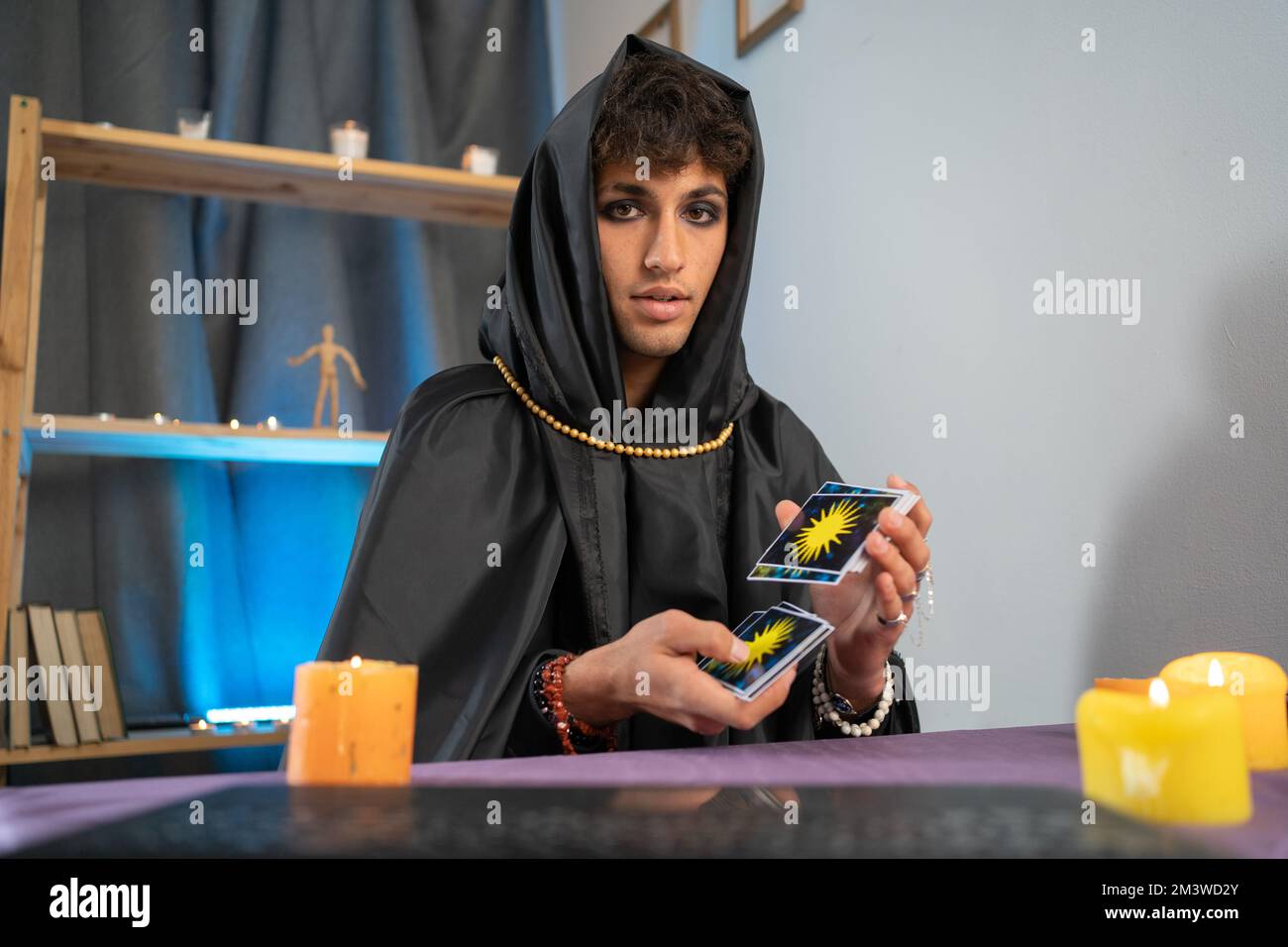 Divination session online. Young male fortune teller reading tarot ...