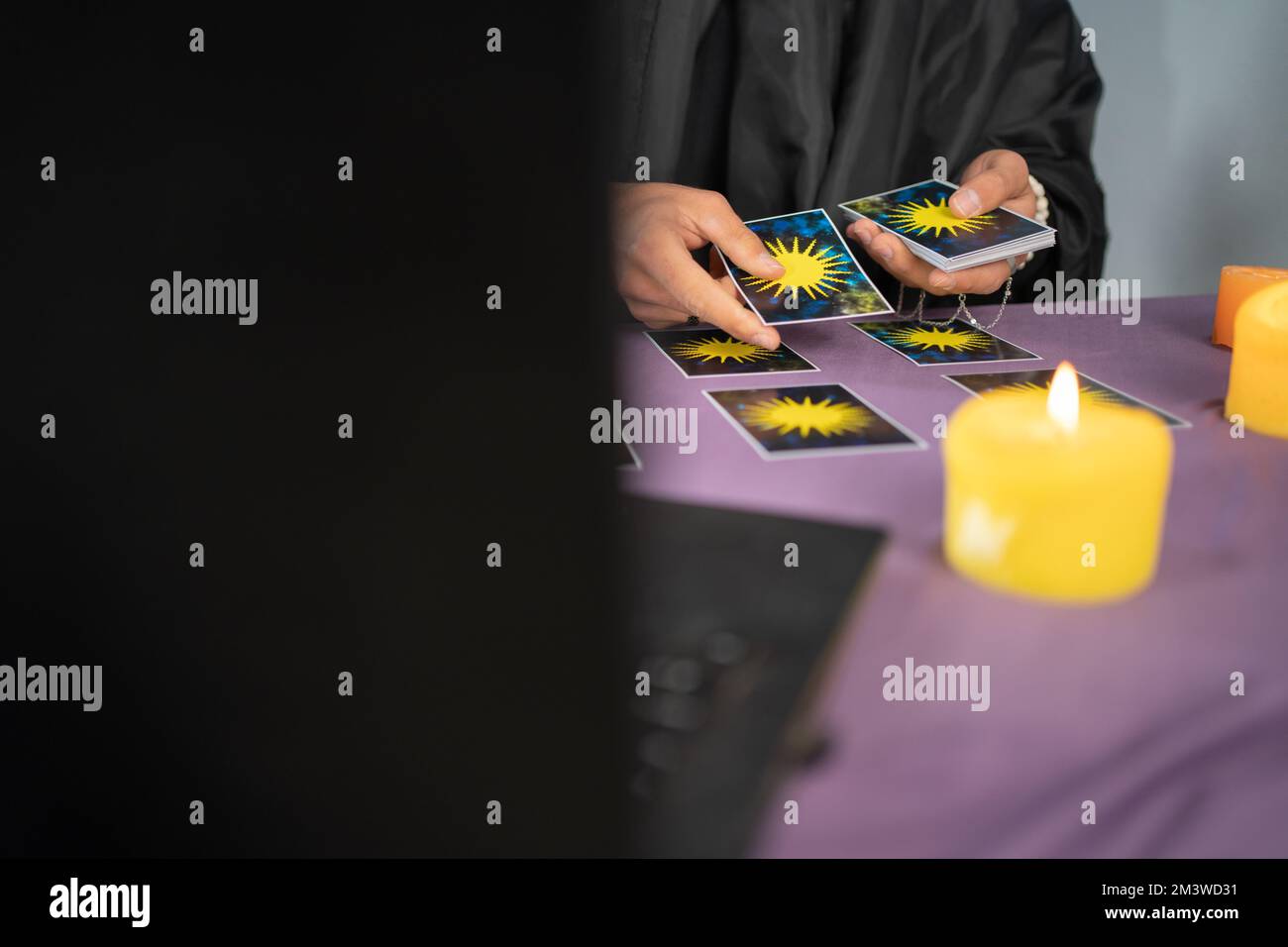 Close up hands of Psychic tarot card reader on laptop computer having ...