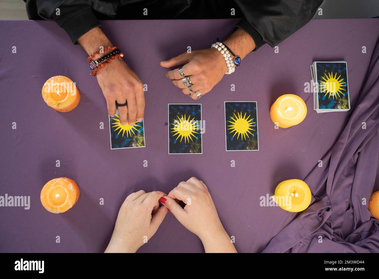 Man fortune teller holding tarot cards in his hands and unrecognizable ...